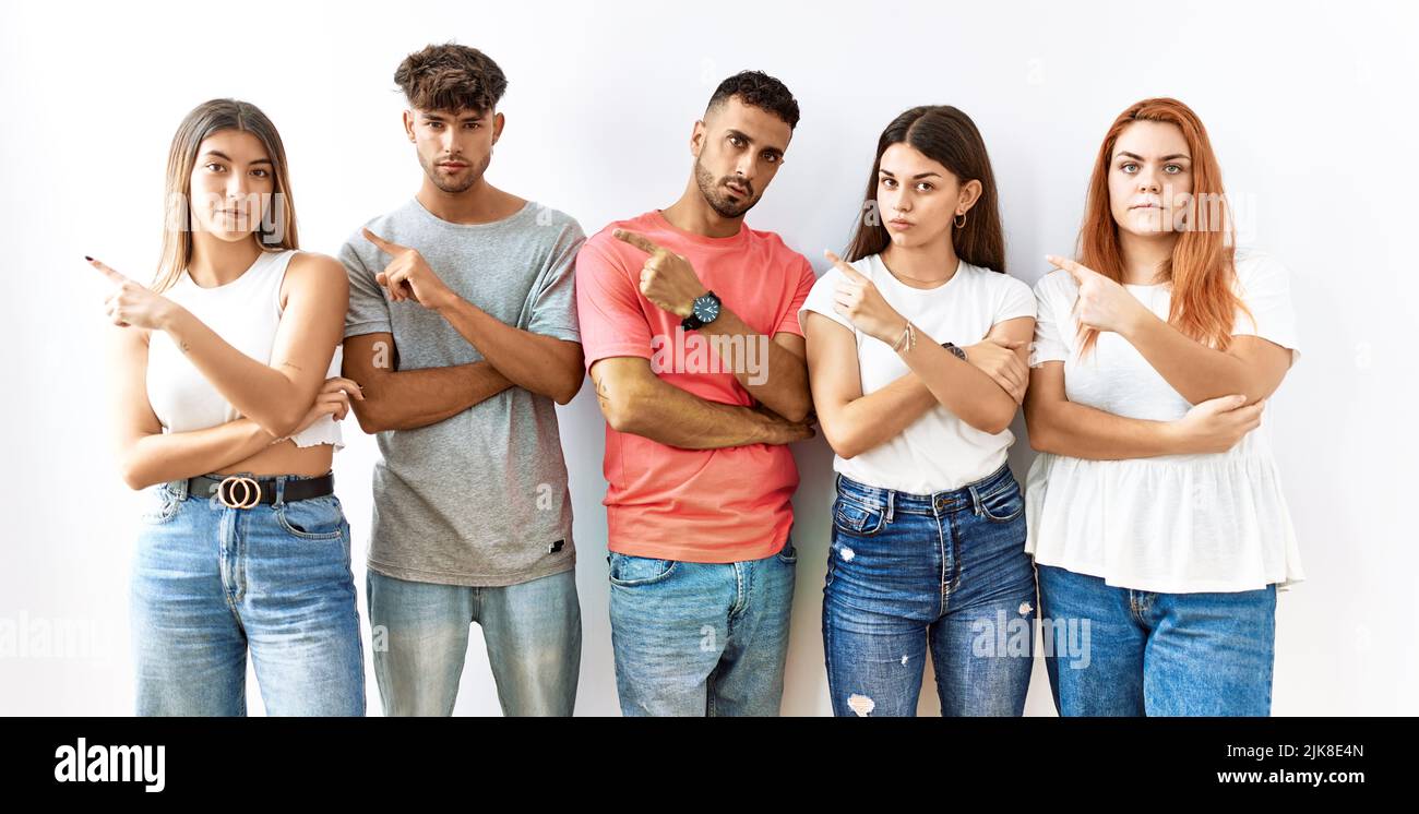Group of young friends standing together over isolated background ...