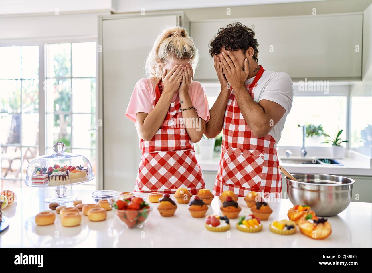 Couple of wife and husband cooking pastries at the kitchen with sad ...
