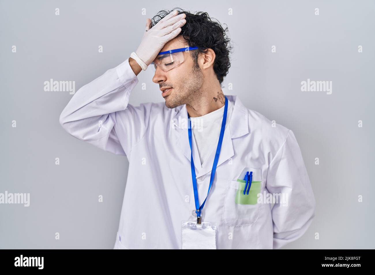 Hispanic man working at scientist laboratory surprised with hand on ...