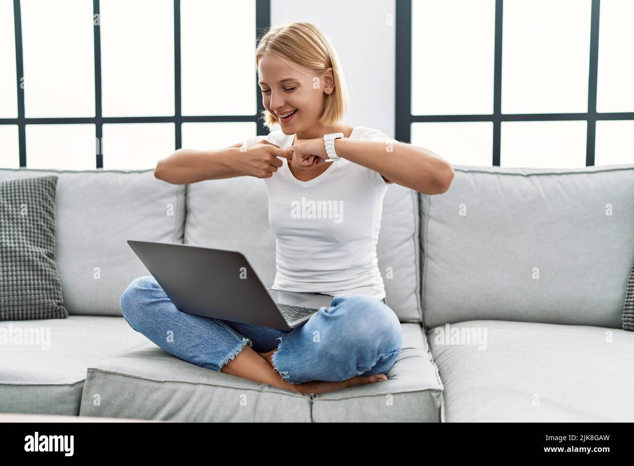 Young blonde woman having video call communicating with deaf sign ...
