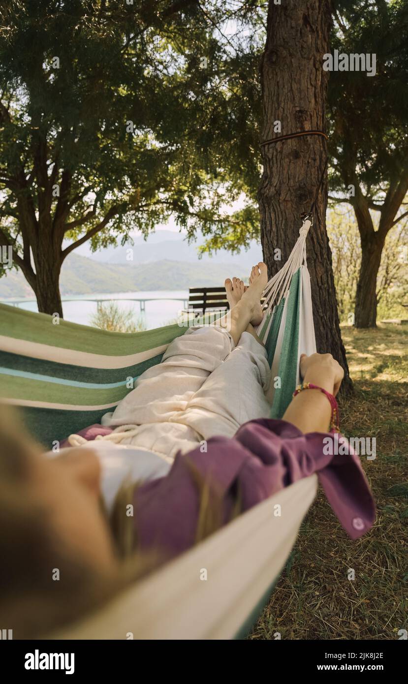 Woman on hammock hi-res stock photography and images - Alamy