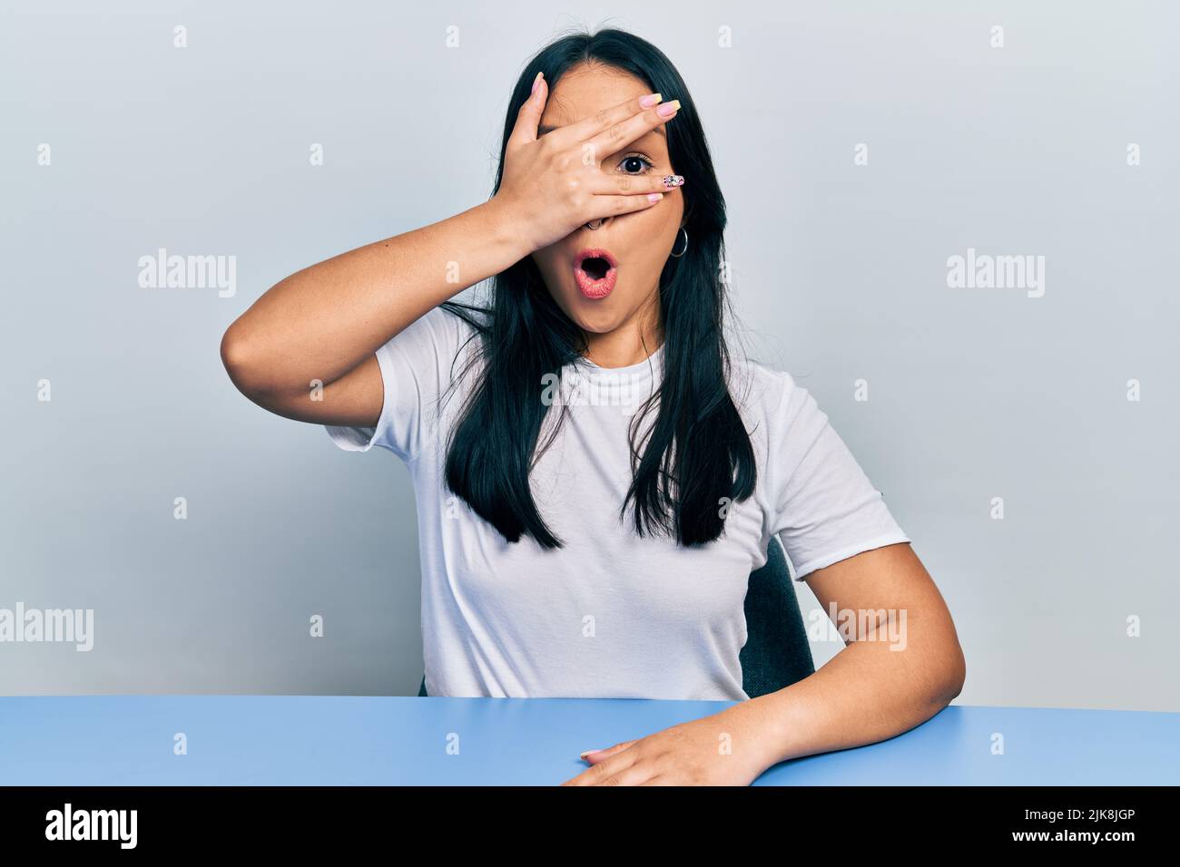 Beautiful hispanic woman with nose piercing wearing casual white t ...
