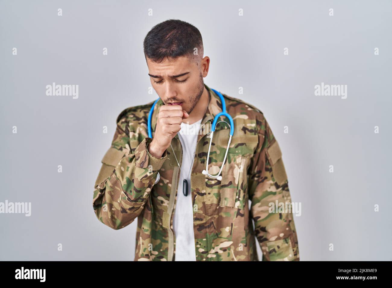 Young hispanic doctor wearing camouflage army uniform feeling unwell ...