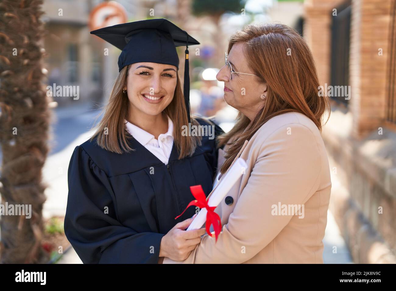 Mother and daughter hugging each other celebrating graduation at ...