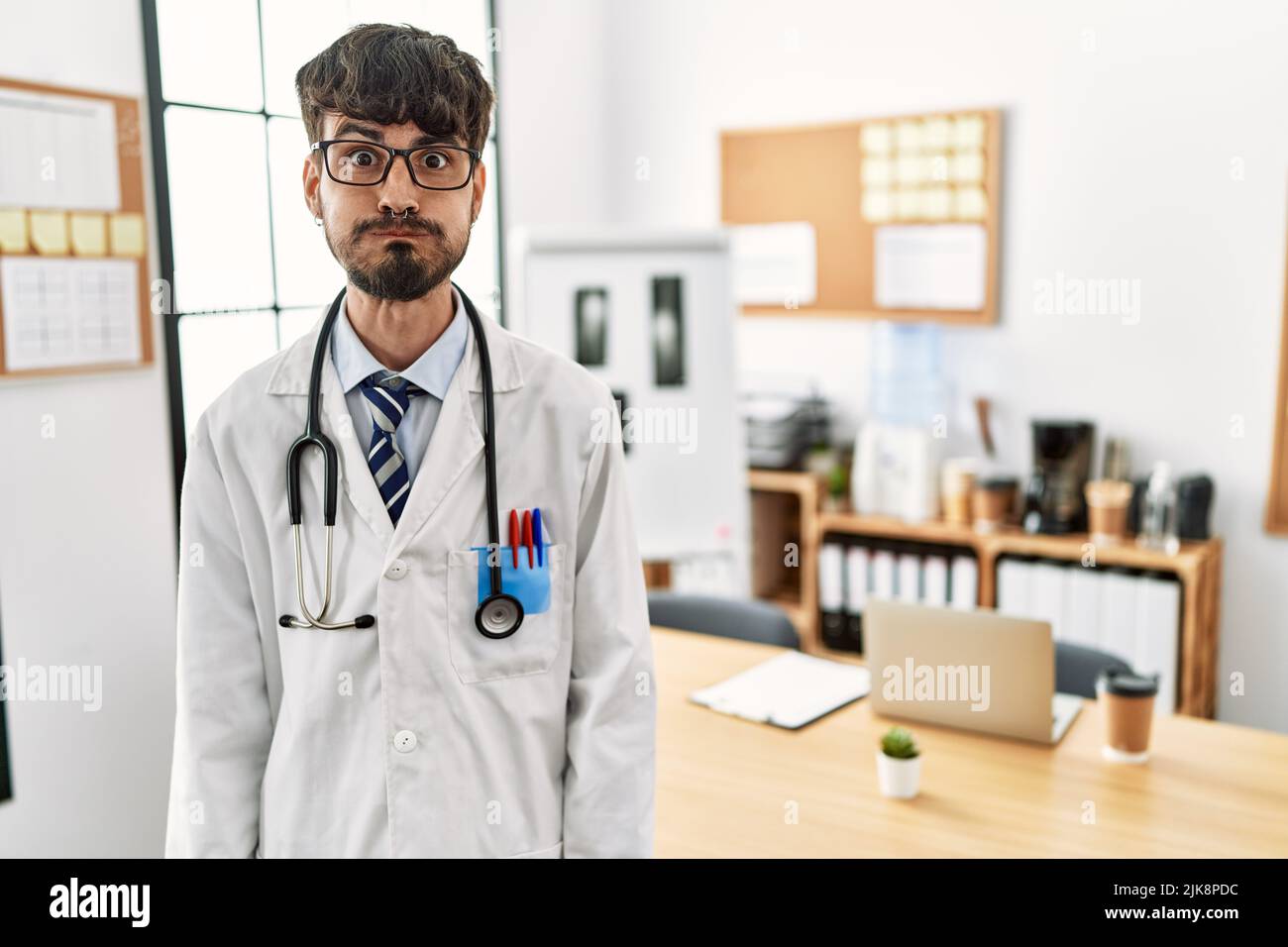 Hispanic Man With Beard Wearing Doctor Uniform And Stethoscope At The