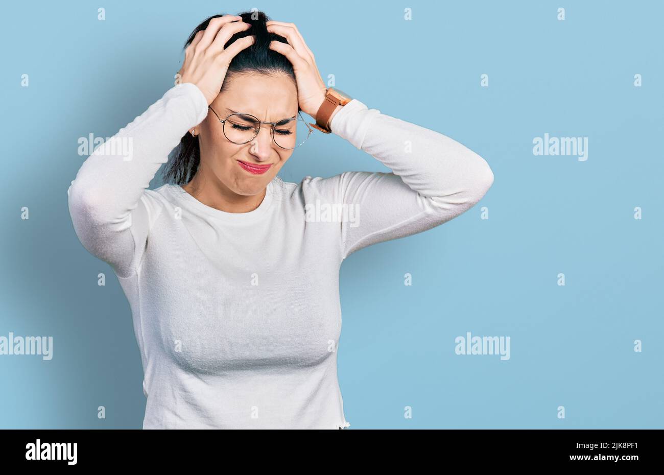Young hispanic woman wearing casual clothes suffering from headache ...