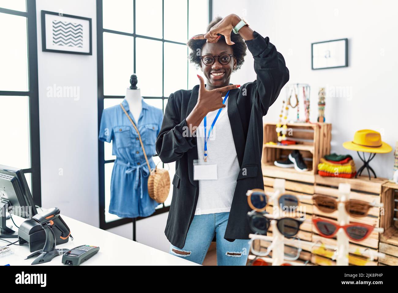 African young woman working as manager at retail boutique smiling ...