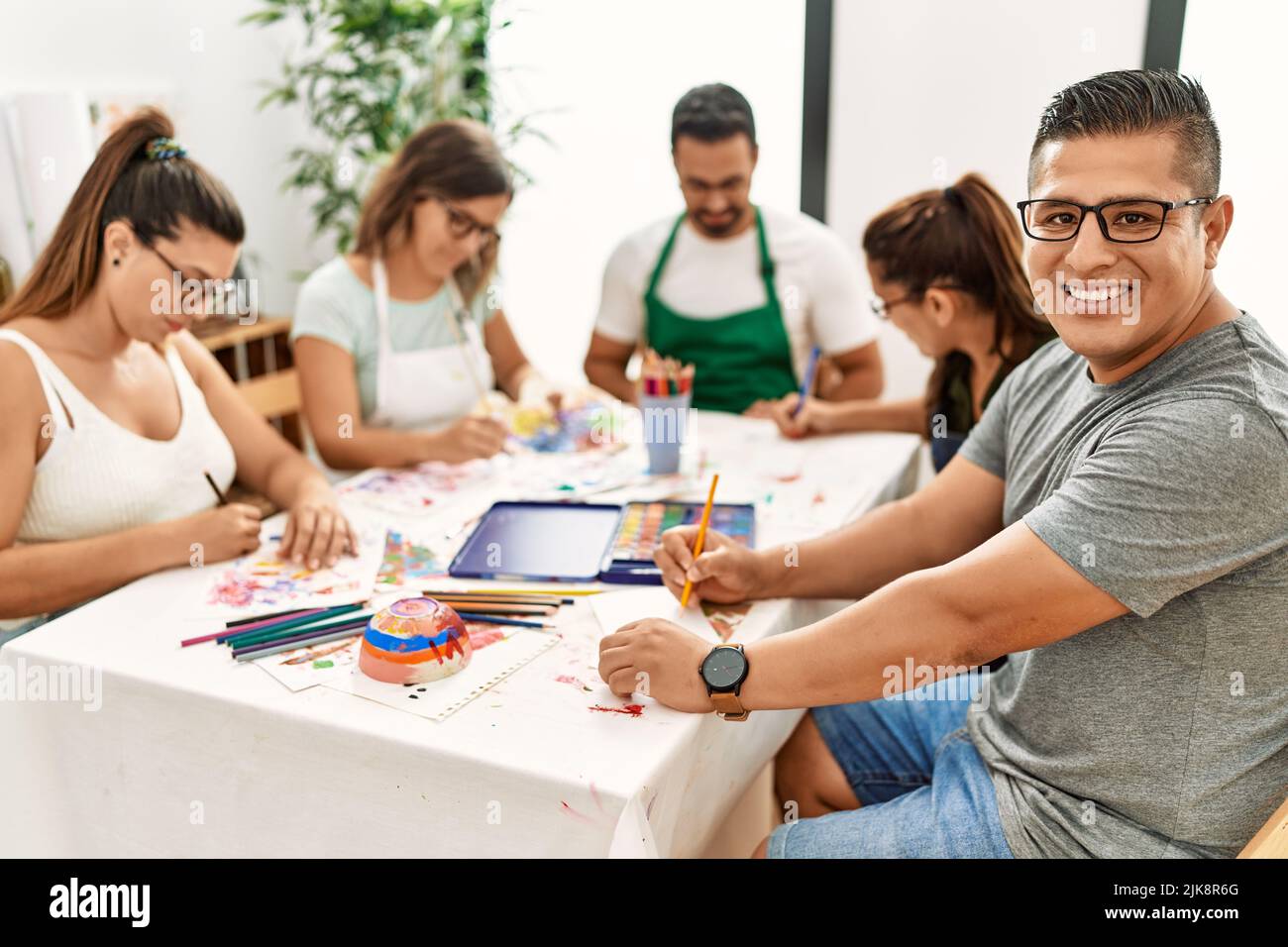 Group of draw students sitting on the table drawing at art studio Stock ...