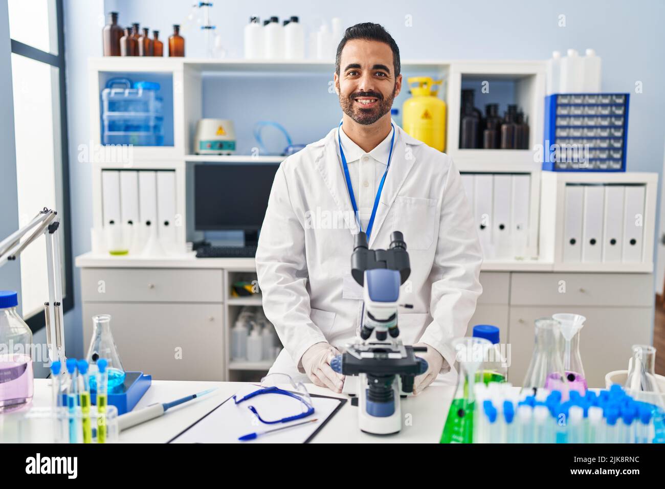 Young hispanic man with beard working at scientist laboratory with a ...