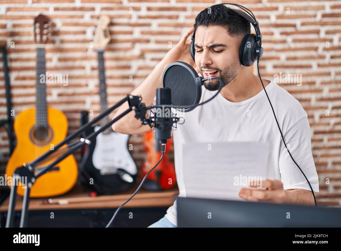 Young arab man artist singing song at music studio Stock Photo - Alamy
