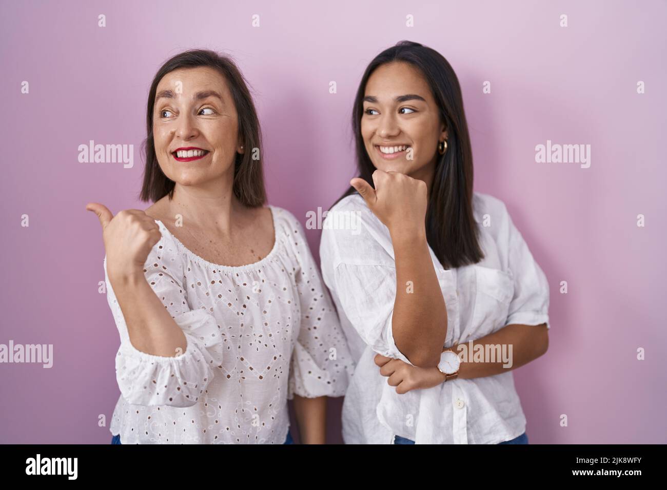 Hispanic mother and daughter together smiling with happy face looking ...