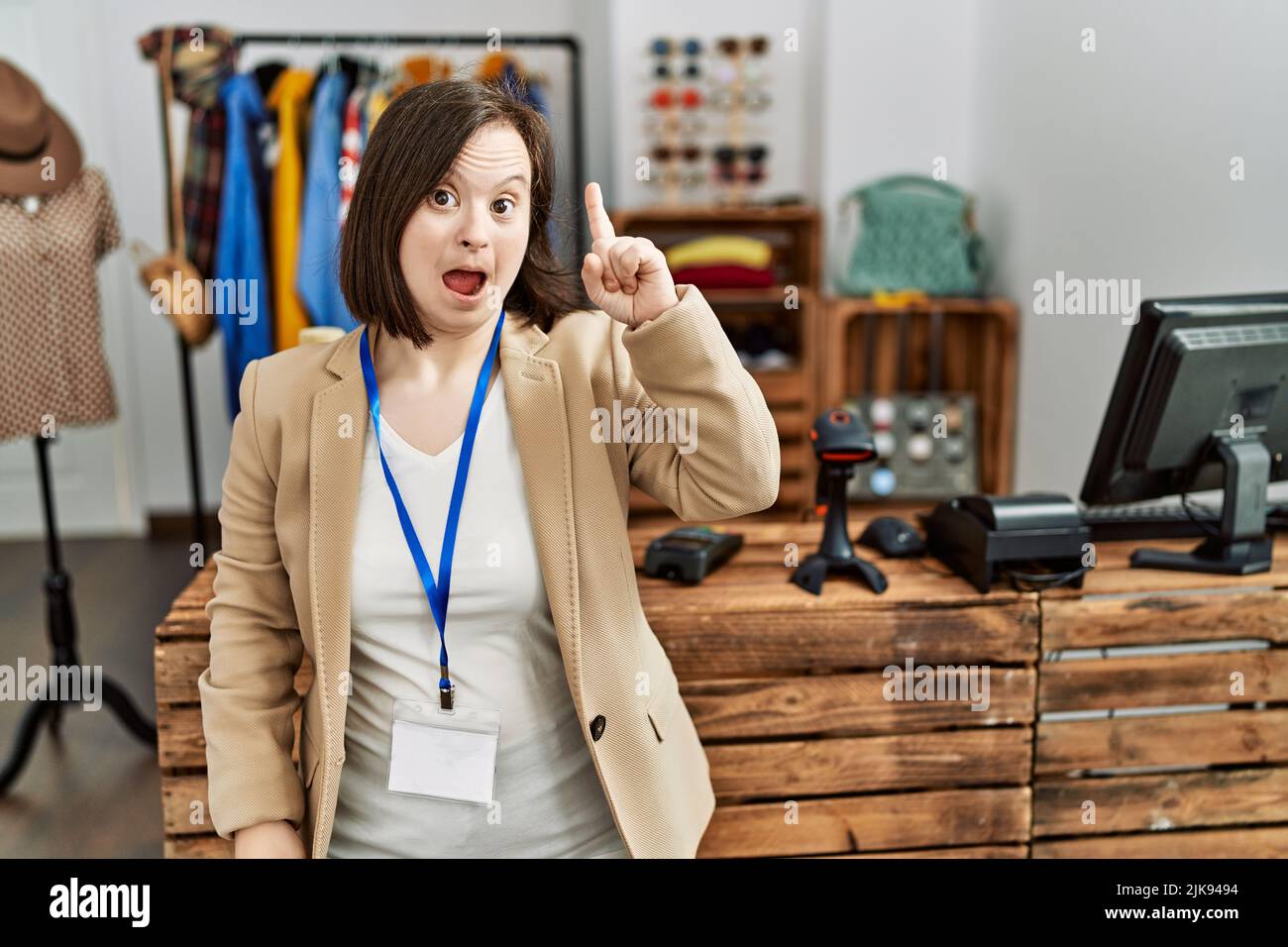 Young down syndrome woman working as manager at retail boutique ...