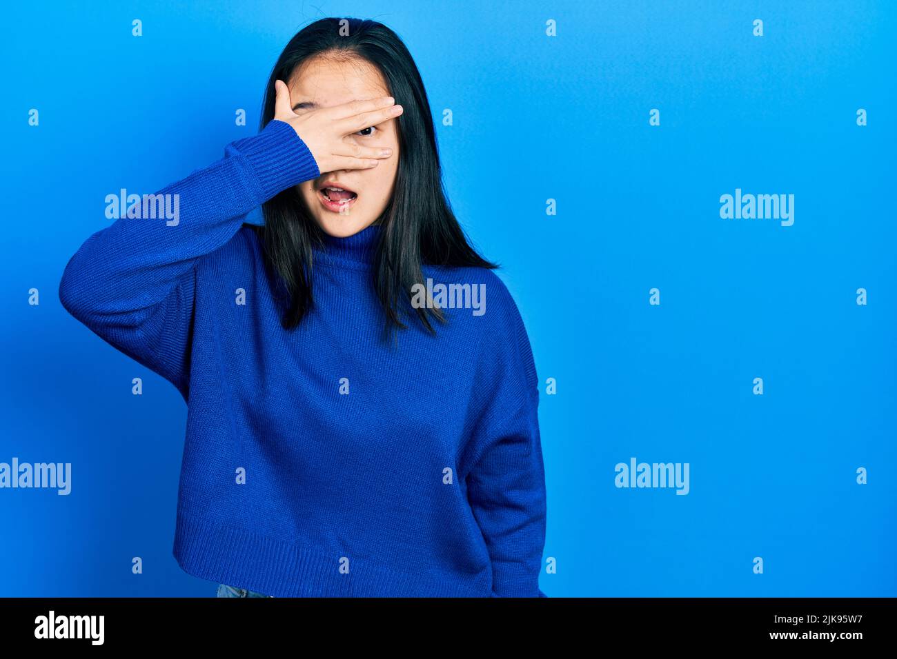Young Chinese Girl Wearing Casual Clothes Peeking In Shock Covering 2057