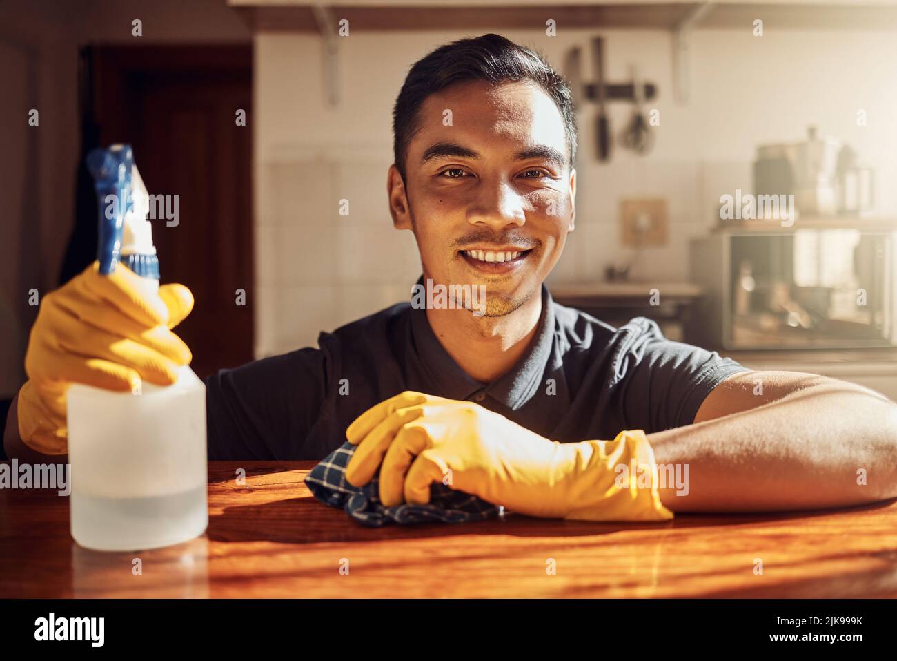 I clean up good. Portrait of a young man disinfecting a kitchen counter ...