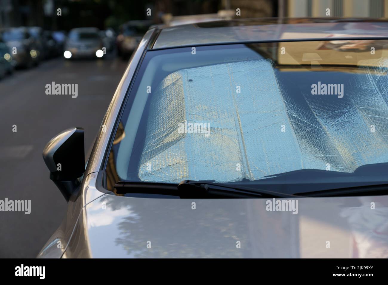 Protective reflective surface under windshield of car on hot day ...