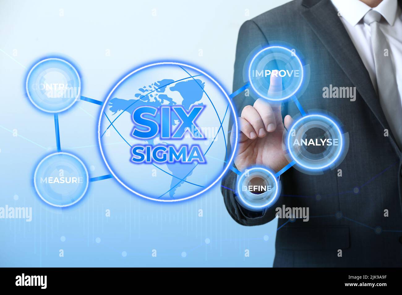 Businessman using virtual screen on light blue background. 6 sigma ...