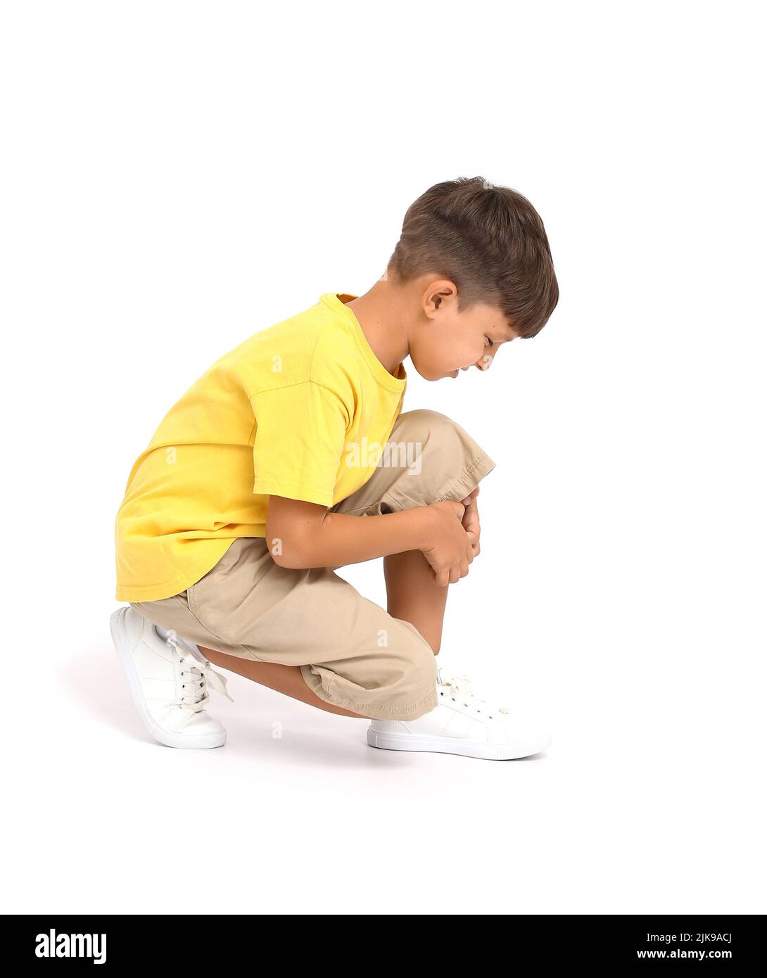 Little boy scratching himself on white background Stock Photo - Alamy