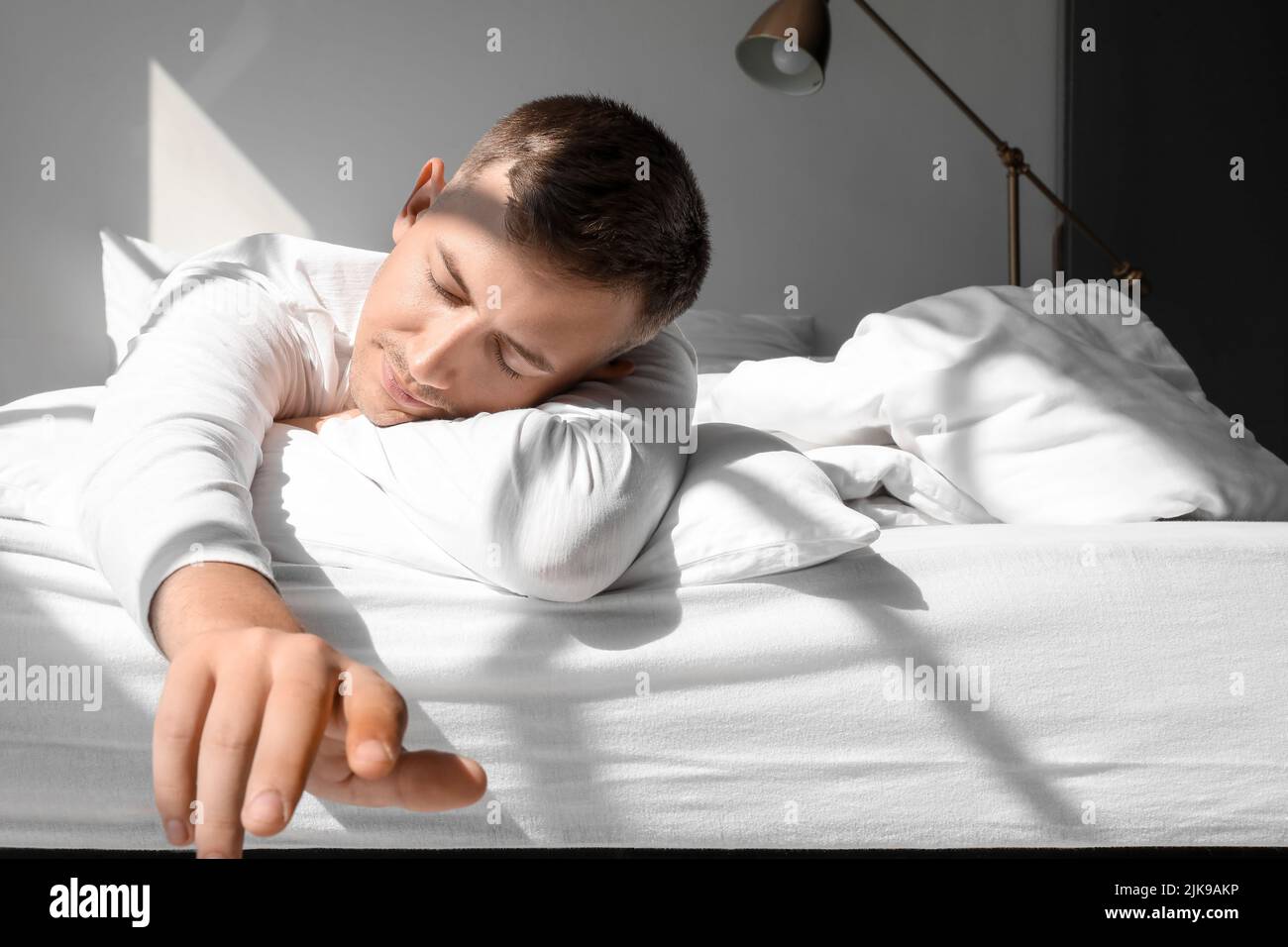 Handsome young man sleeping on bed at home, closeup Stock Photo - Alamy
