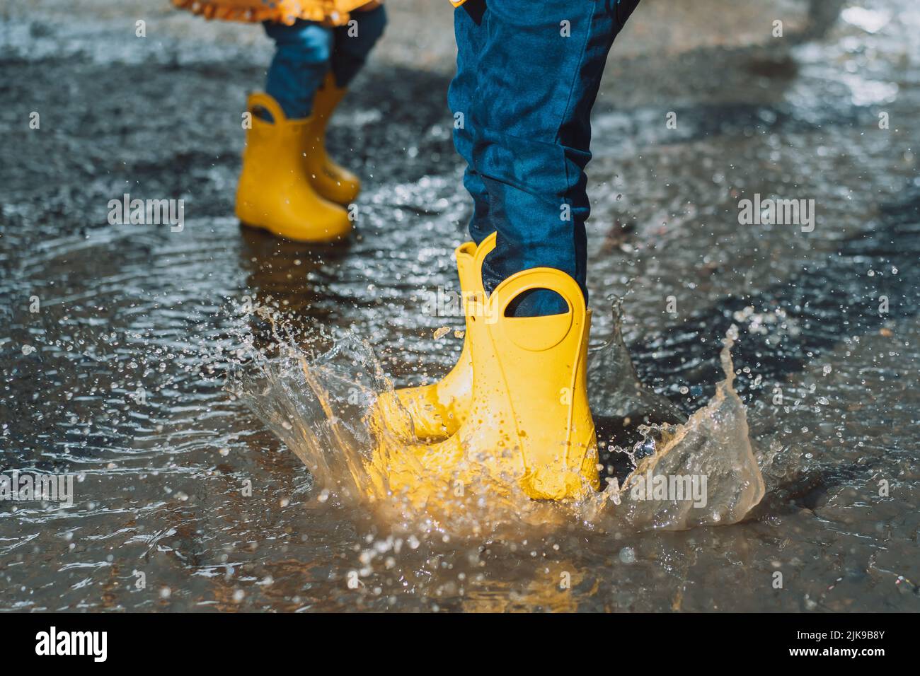 Children jumping in puddles hi-res stock photography and images - Alamy