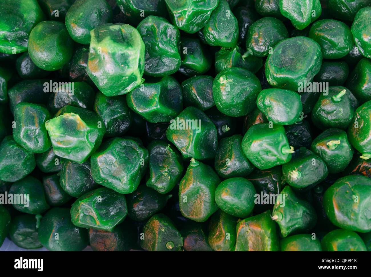 Lot of sweet green candied fruits from dried fruits on the counter of ...