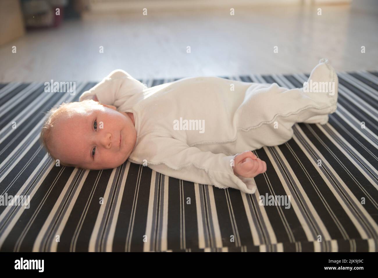 A little newborn baby lying on his back Stock Photo - Alamy
