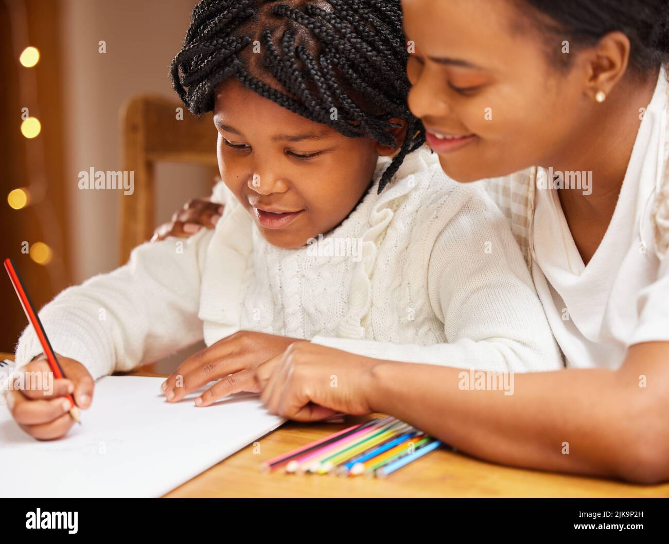 Mom makes doing homework fun. a young mother and daughter doing ...