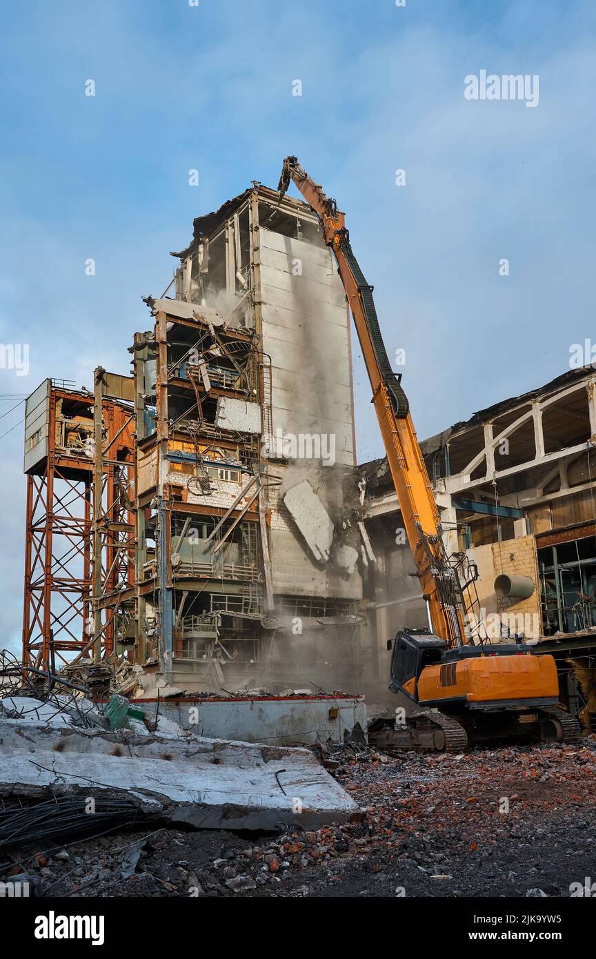 Destroying of old industrial building by excavator destroyer Stock ...