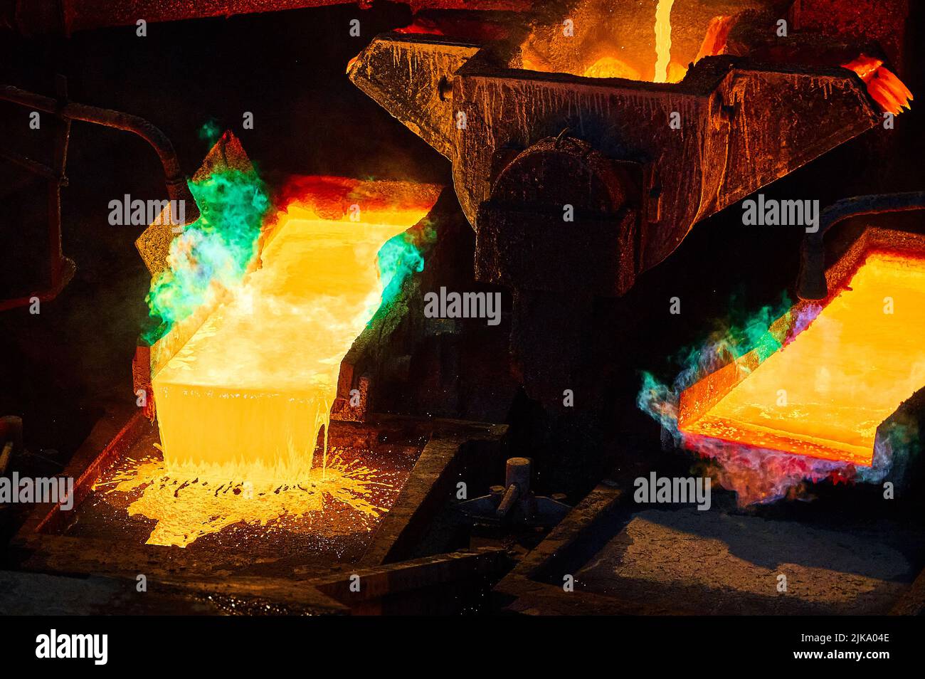 Pouring liquid copper metal for anodes into form in workshop Stock ...