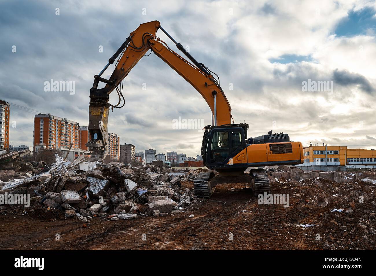 Excavator destroyer with hydraulic scissors cuts concrete Stock Photo ...