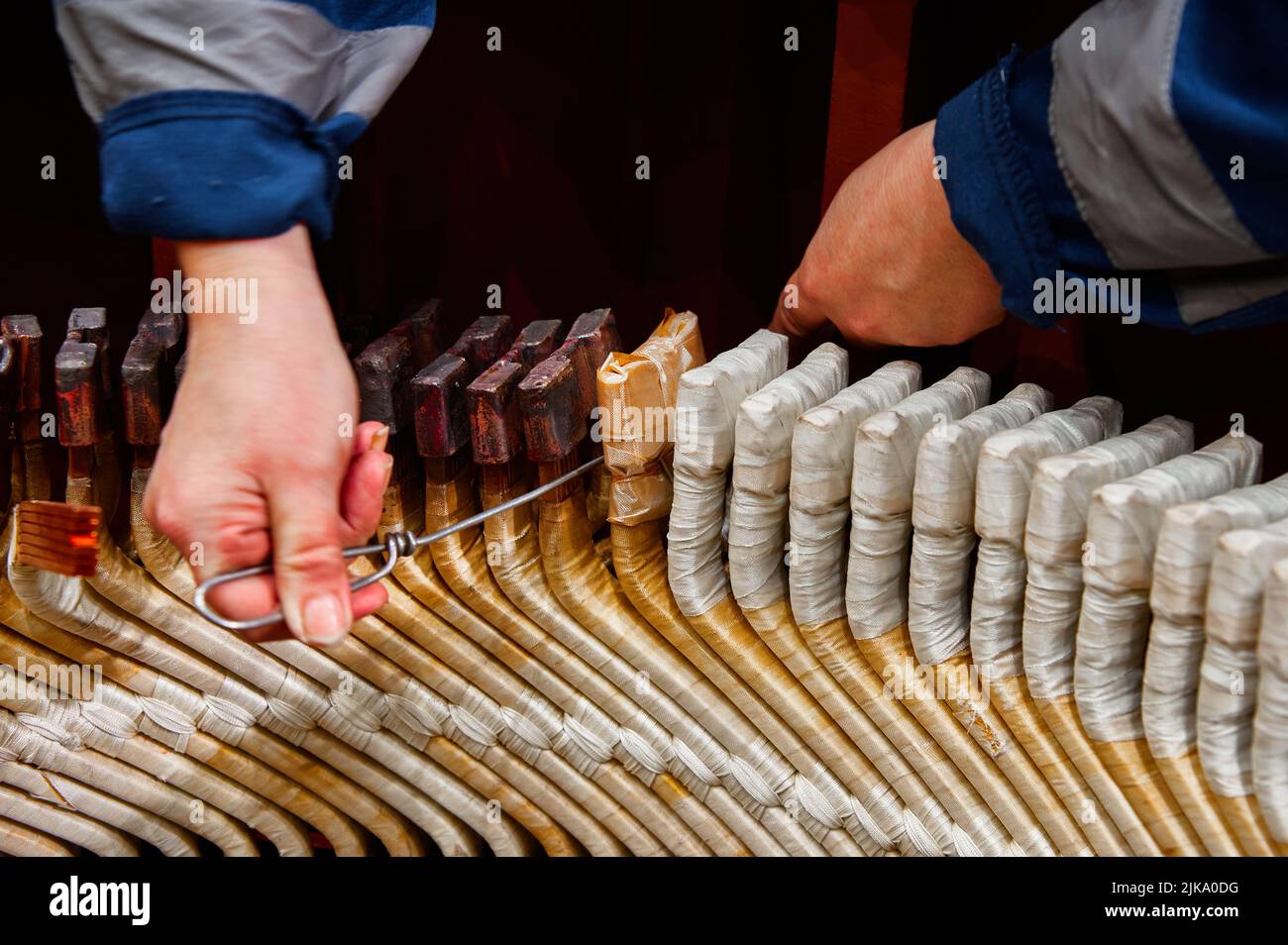 Worker wraps stator copper bus bars with insulation fabric Stock Photo ...