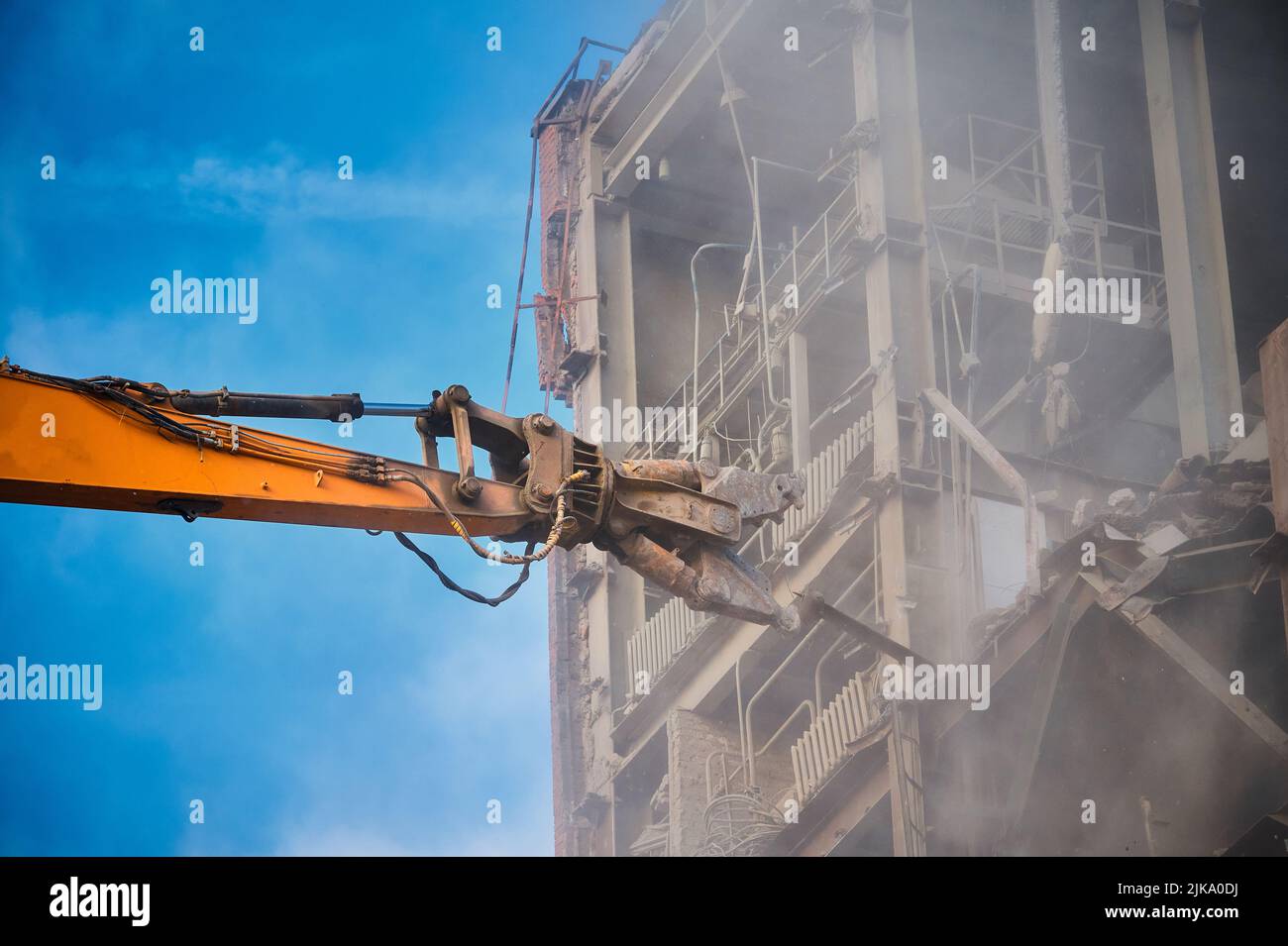 Hydraulic scissors on rig of crane cut building on site Stock Photo - Alamy