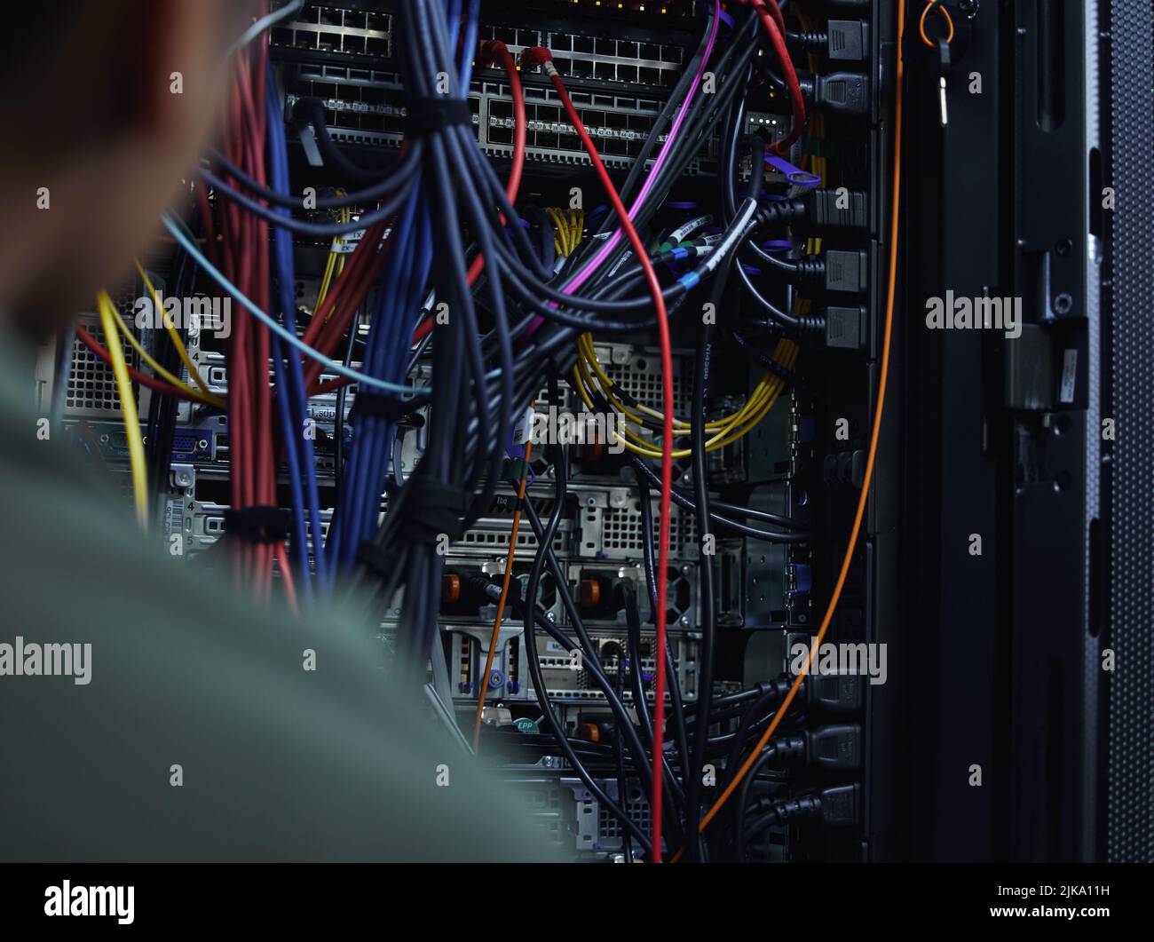 Lets organize this cabling. an unrecognizable male IT support agent ...