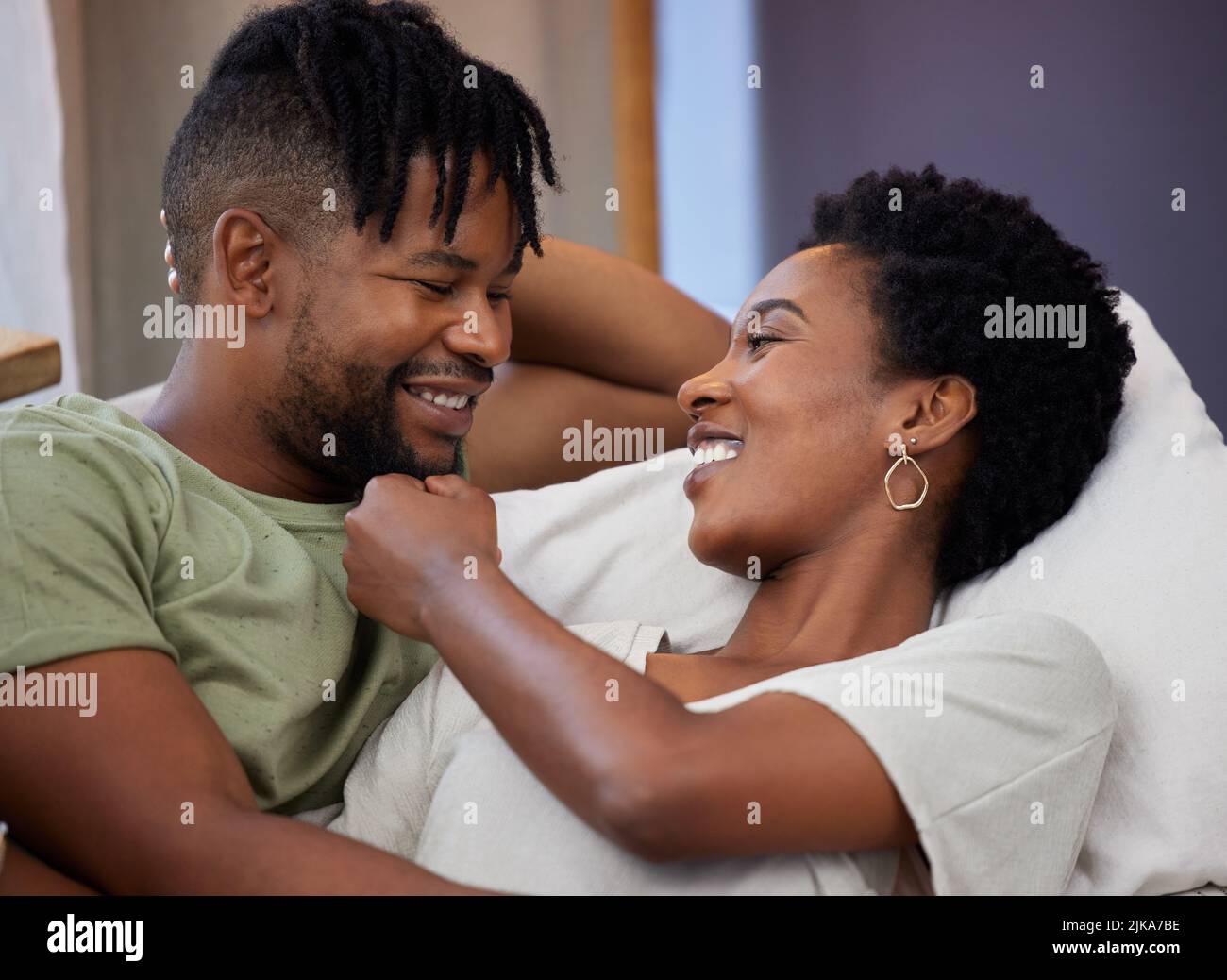 Husband and wife embracing on couch hi-res stock photography and images ...