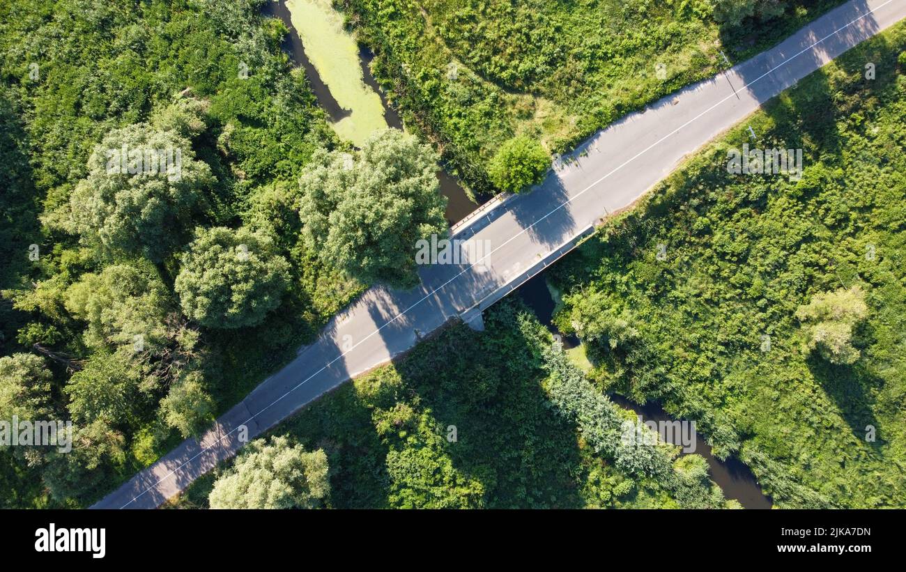 bridge over the river that flows through the fields and meadows ...