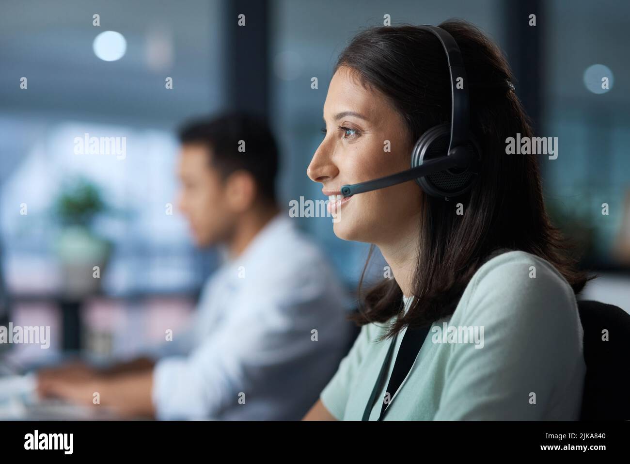 On your side every step of the way. a young woman using a headset in a ...