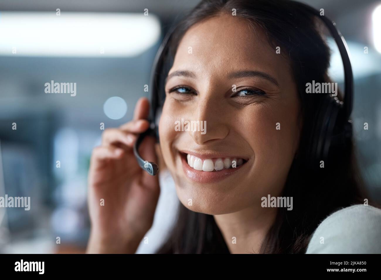 Relax, youve called the right place. Portrait of a young woman using a ...