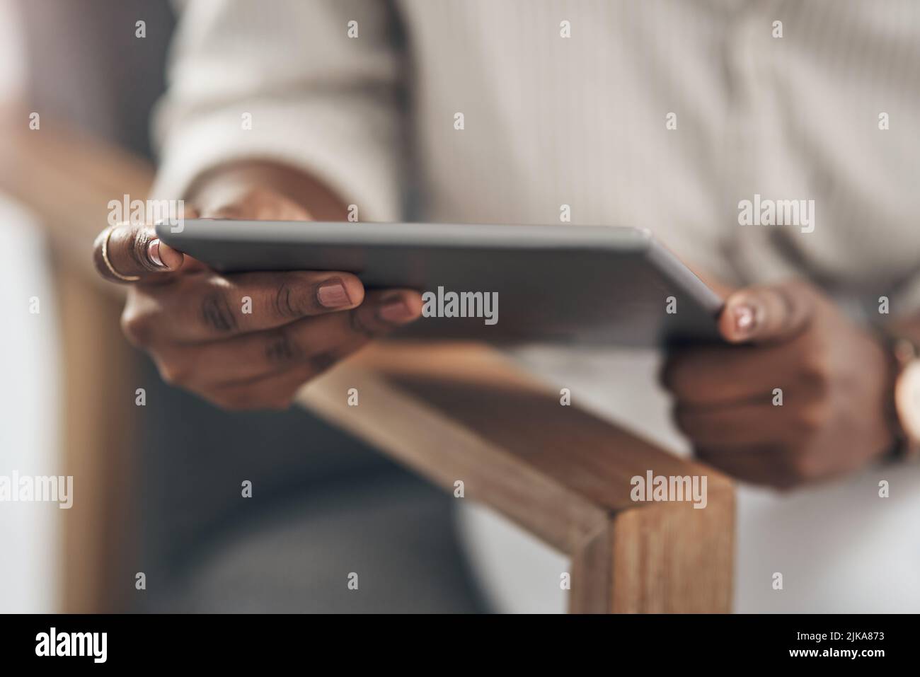 I keep my tablet on me at all times. a businesswoman using her digital ...