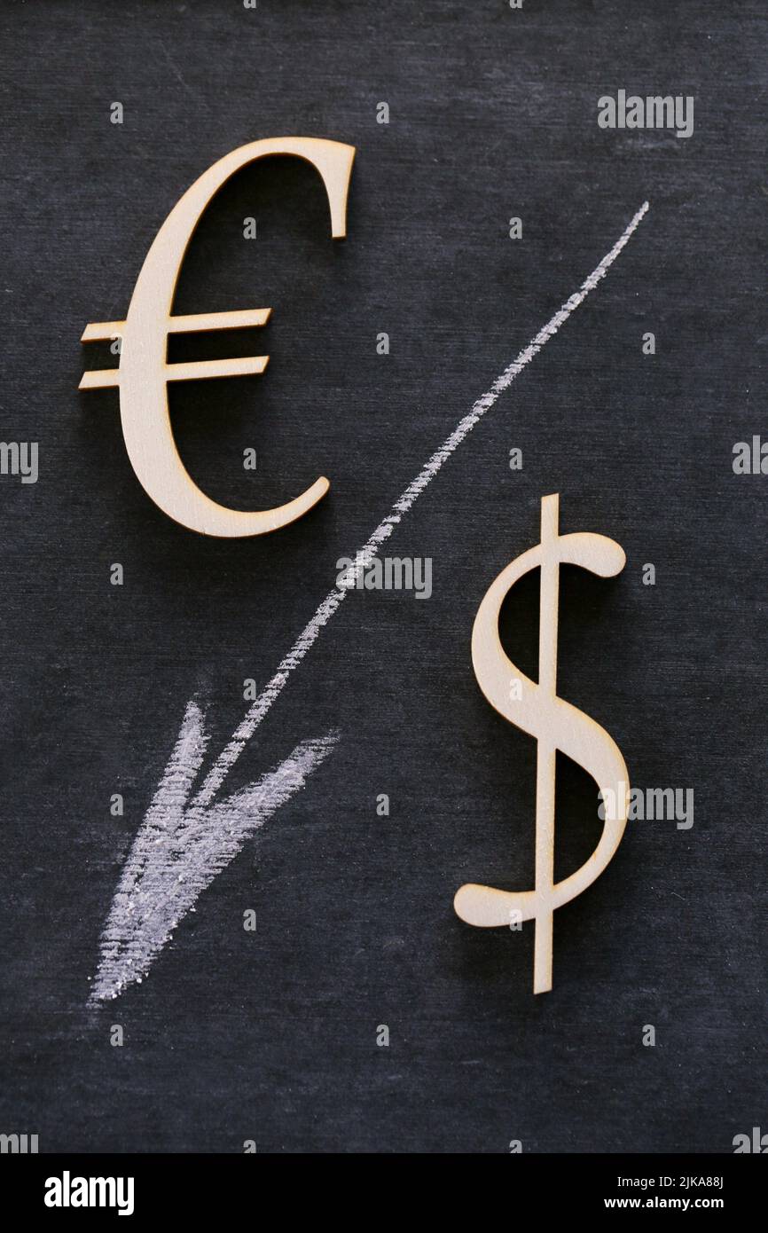 Falling currency rate. Euro and Dollar sign and a white down arrow on a ...
