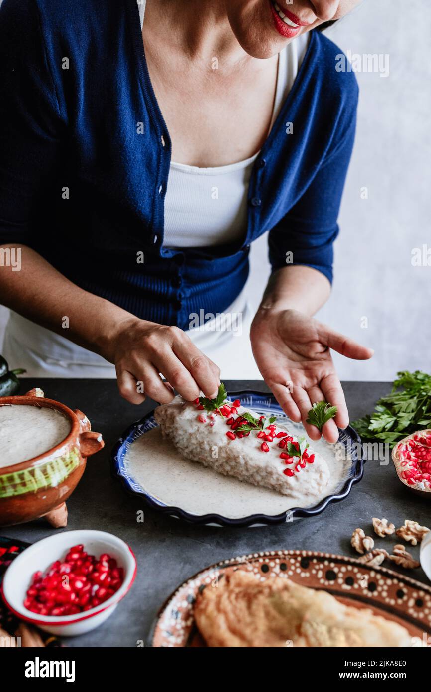 mexican woman cooking chiles en nogada recipe with Poblano chili and ...