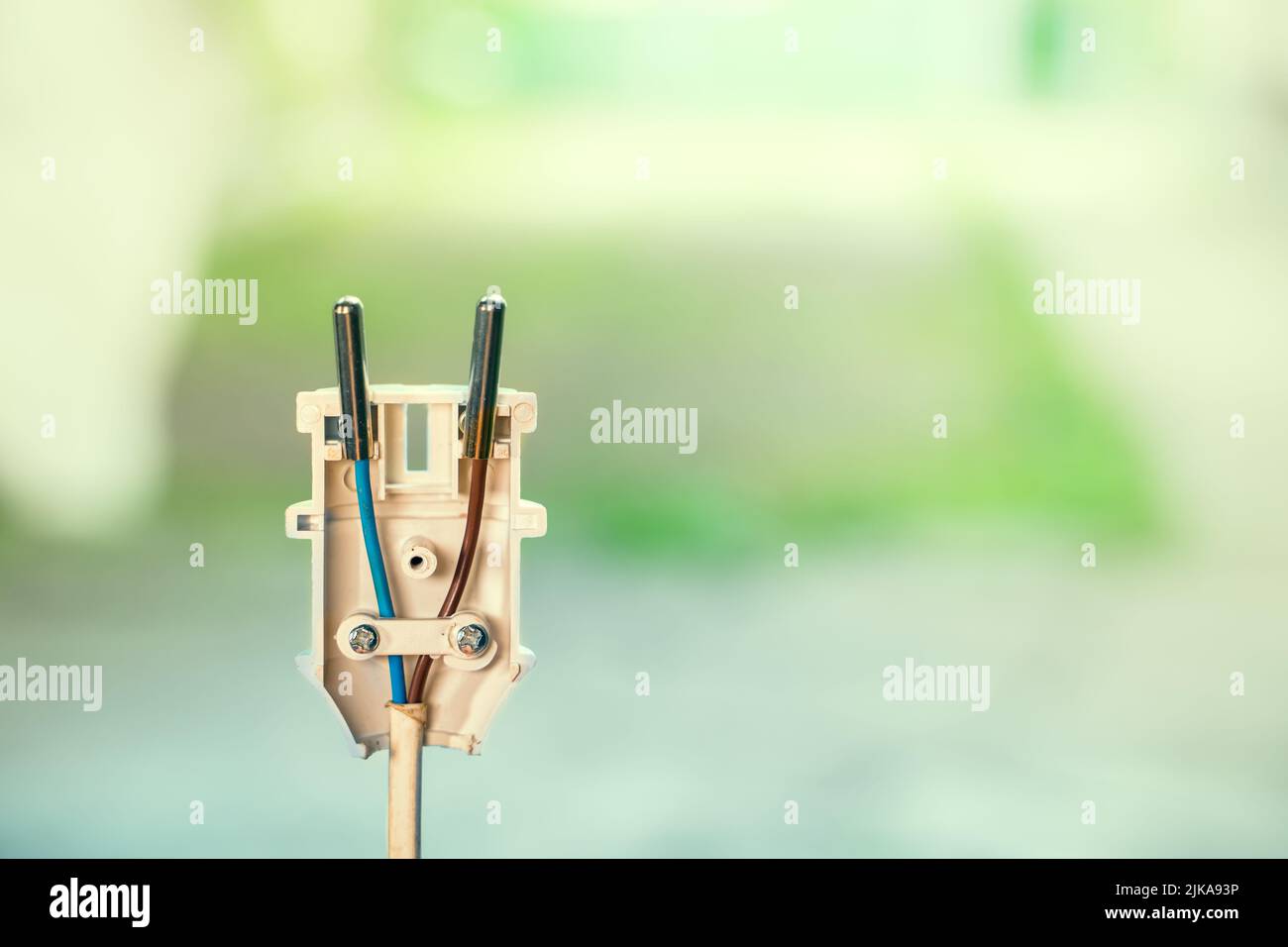 Connecting the wires of an electrical appliance into an electrical plug ...