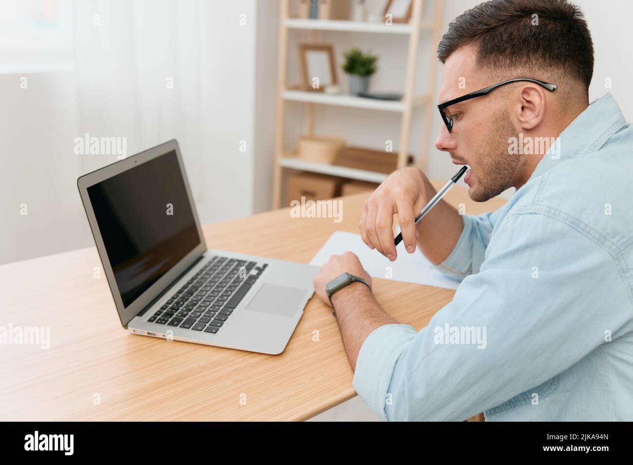 View from back. Serious focused handsome businessman work online using ...