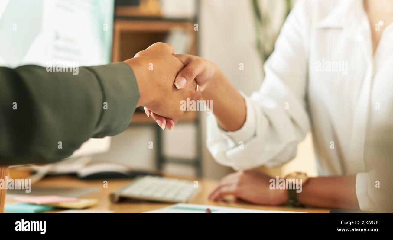 Im so glad youre finally here. two businesswoman shaking hands in ...