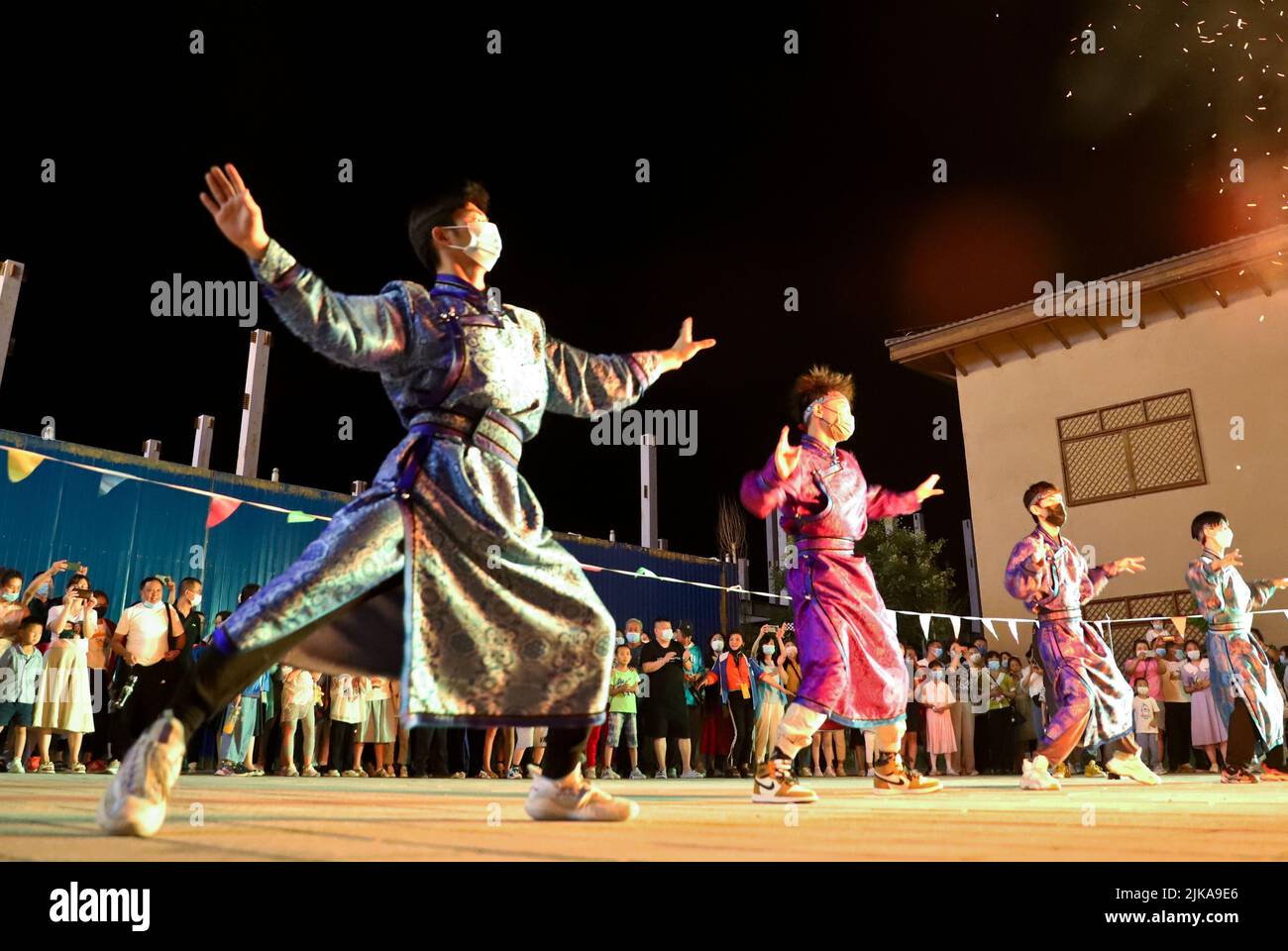 ZHANGYE, CHINA - JULY 31, 2022 - People teach tourists Guozhuang dance ...