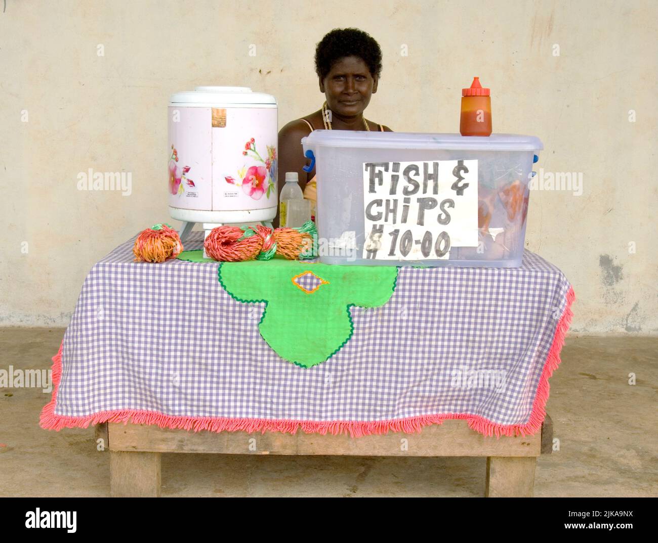 Woman selling fish and chips in the main street, Gizo, Western Province ...
