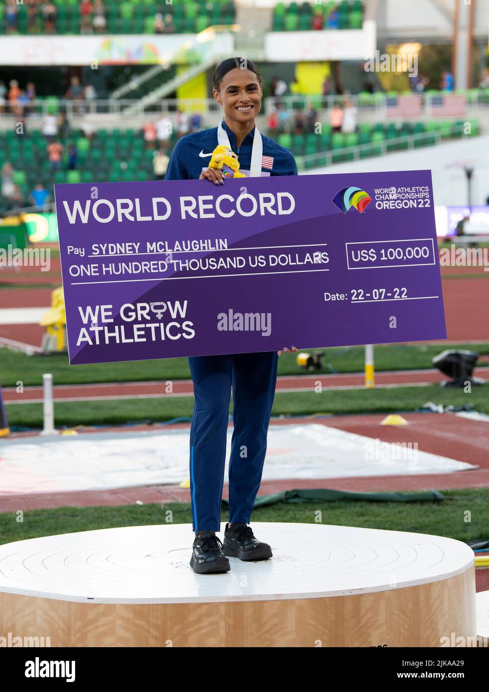 Sydney McLaughlin (USA) receiving a check for $100,000 for breaking the ...