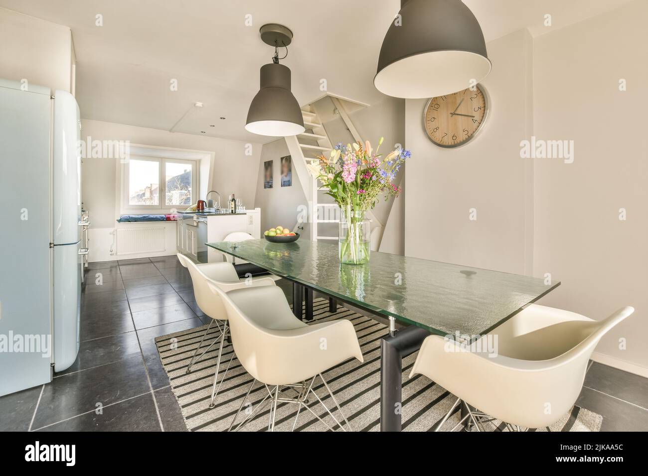 Contemporary cupboards with appliances and tables with kitchenware ...