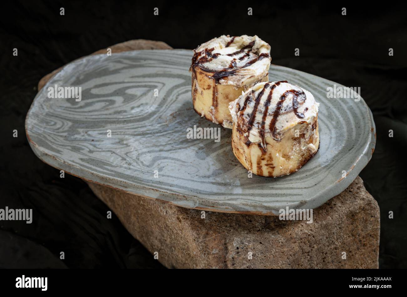 Two Cinnabon Chocobon (Soft Chocolate Buns) topped with rich cream ...