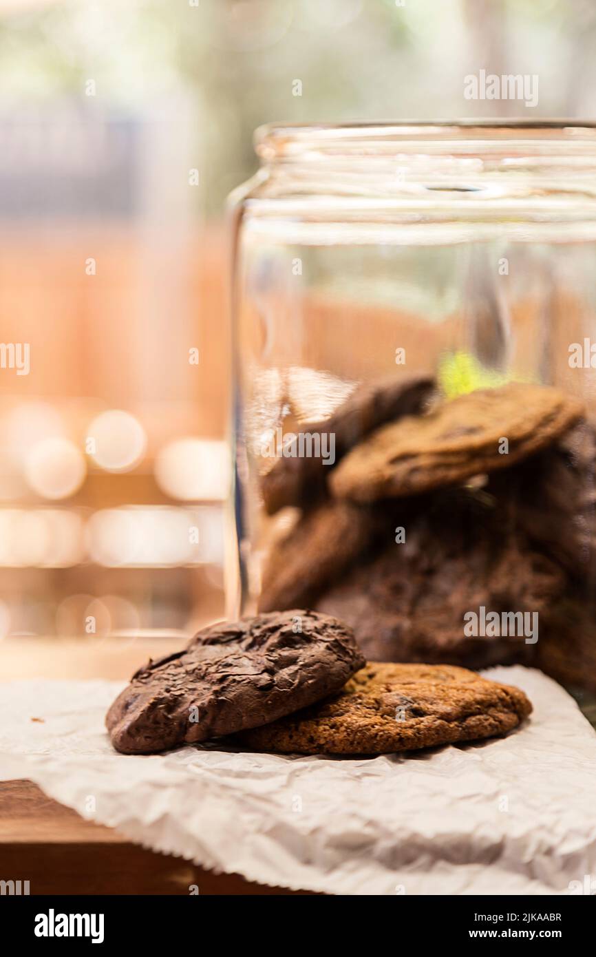 Delicious chocolate and honey cookies and a jar full of cookies in a ...