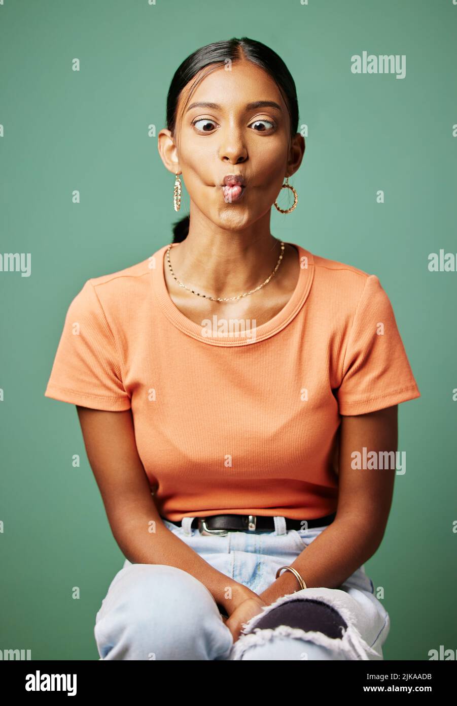 Im so quirky. a woman making a funny face shot against a studio ...