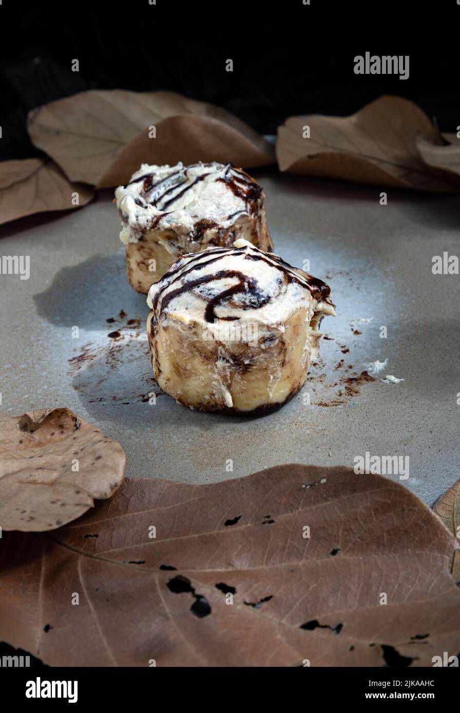 Two Cinnabon Chocobon (Soft Chocolate Buns) topped with rich cream ...